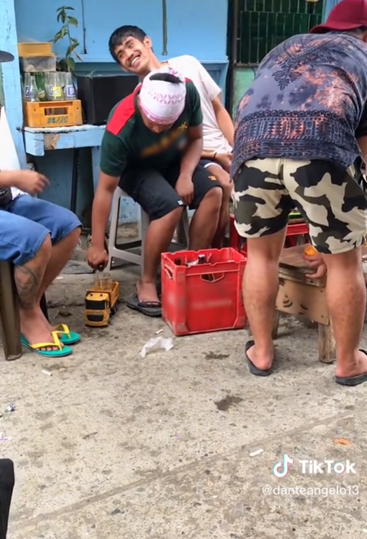 Remote Control Toy Truck Used to Deliver "Tagay" Among Men Having ...